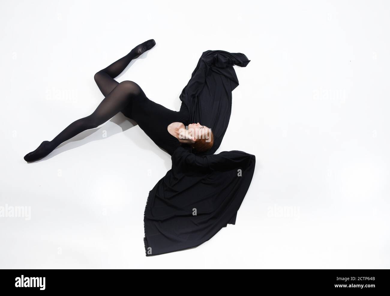 Like a bat. Young and graceful ballet dancer in minimal black style ...