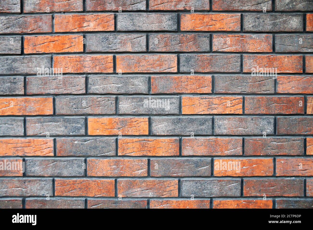 brown mottled decorative brick wall for background Stock Photo - Alamy