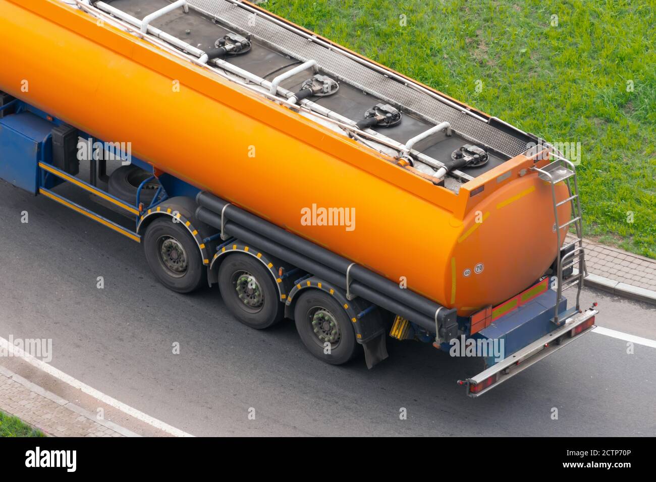 Large orange tank trailer tanker truck rolling on highway Stock Photo ...