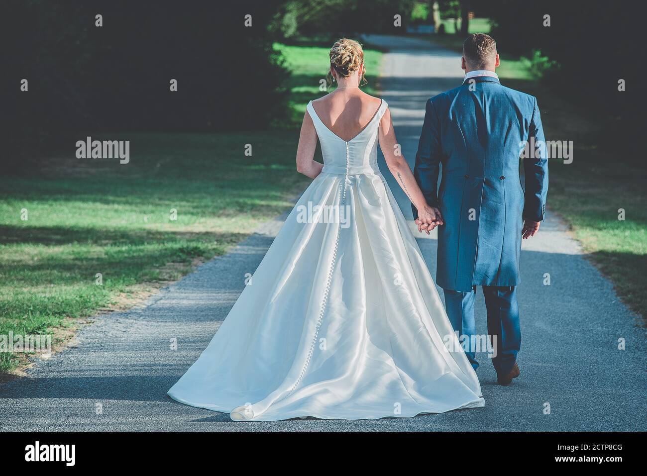 Couple walking on their wedding day Stock Photo - Alamy