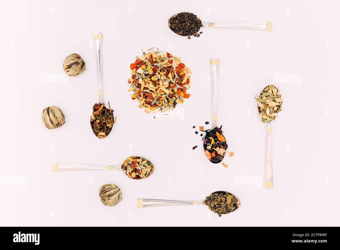 Two cups full with fresh spring tea and scattered dried tea leaves ...