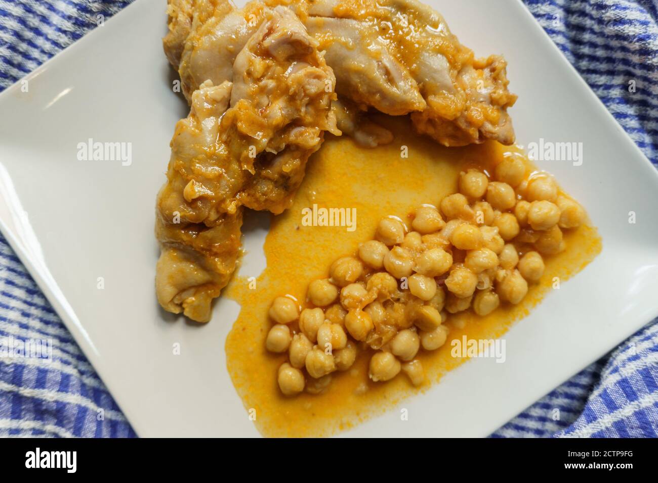 Typical Spanish dish, braised pork legs with chickpeas and cherry ...