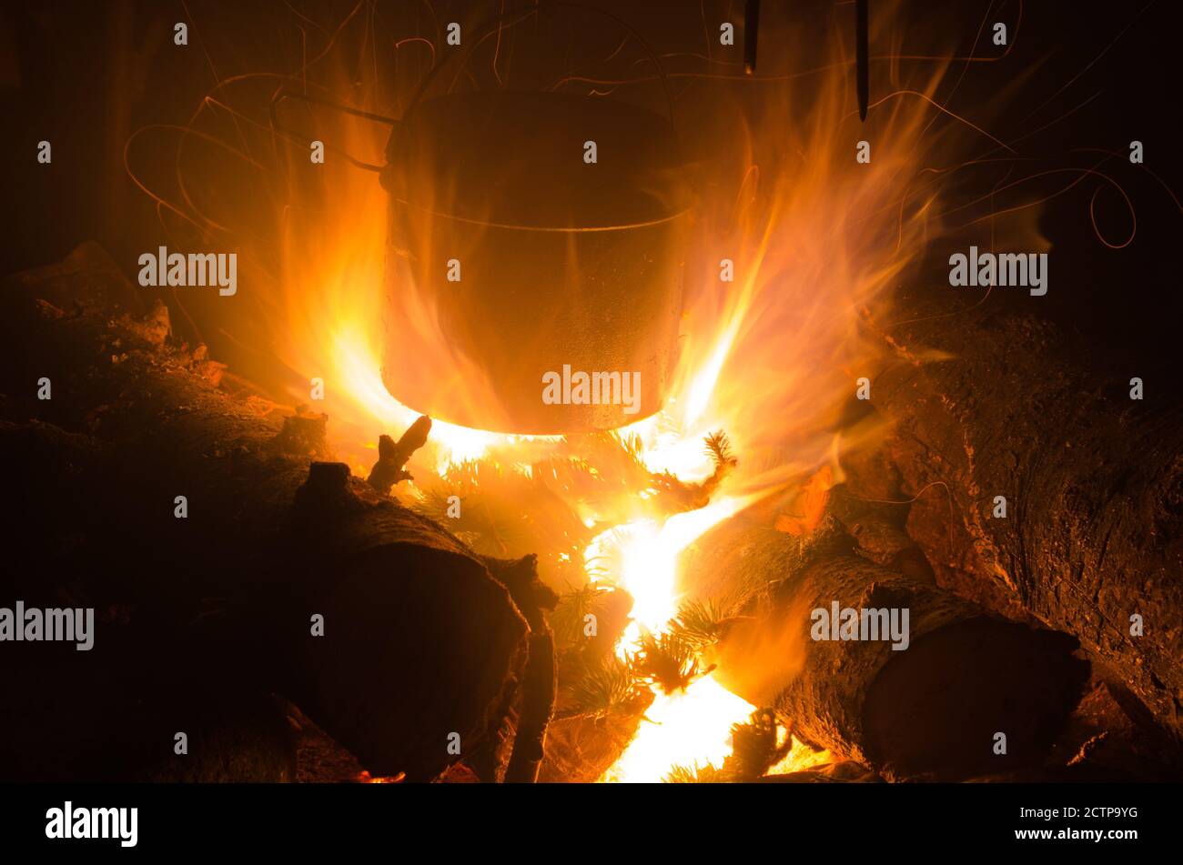 fire burns in the campaign. pot of tea by the fire Stock Photo - Alamy