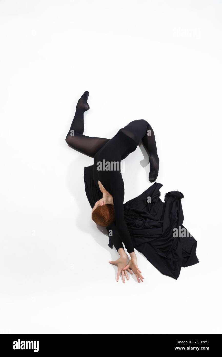 Tender. Young and graceful ballet dancer in minimal black style ...