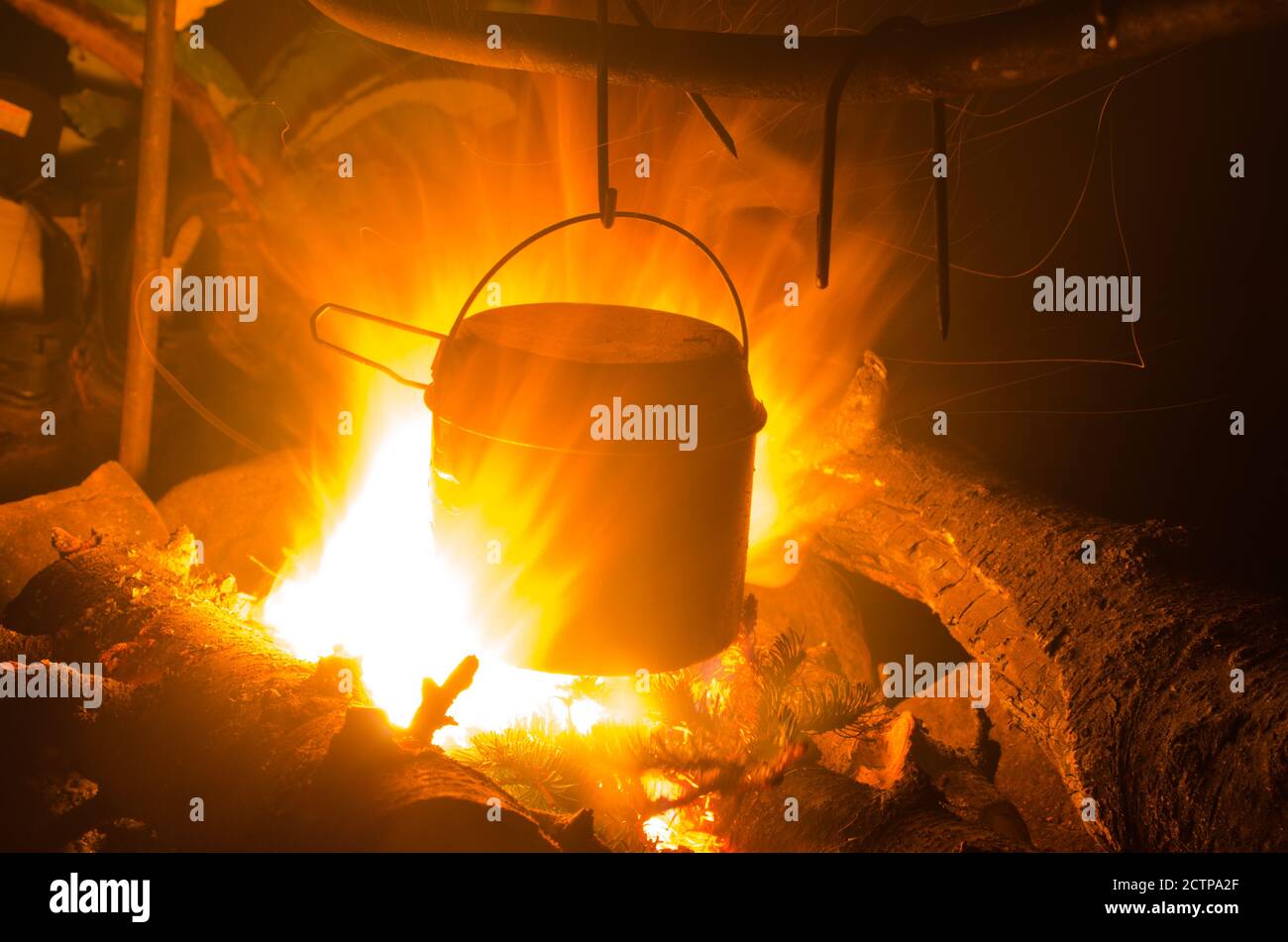 fire burns in the campaign. pot of tea by the fire Stock Photo - Alamy