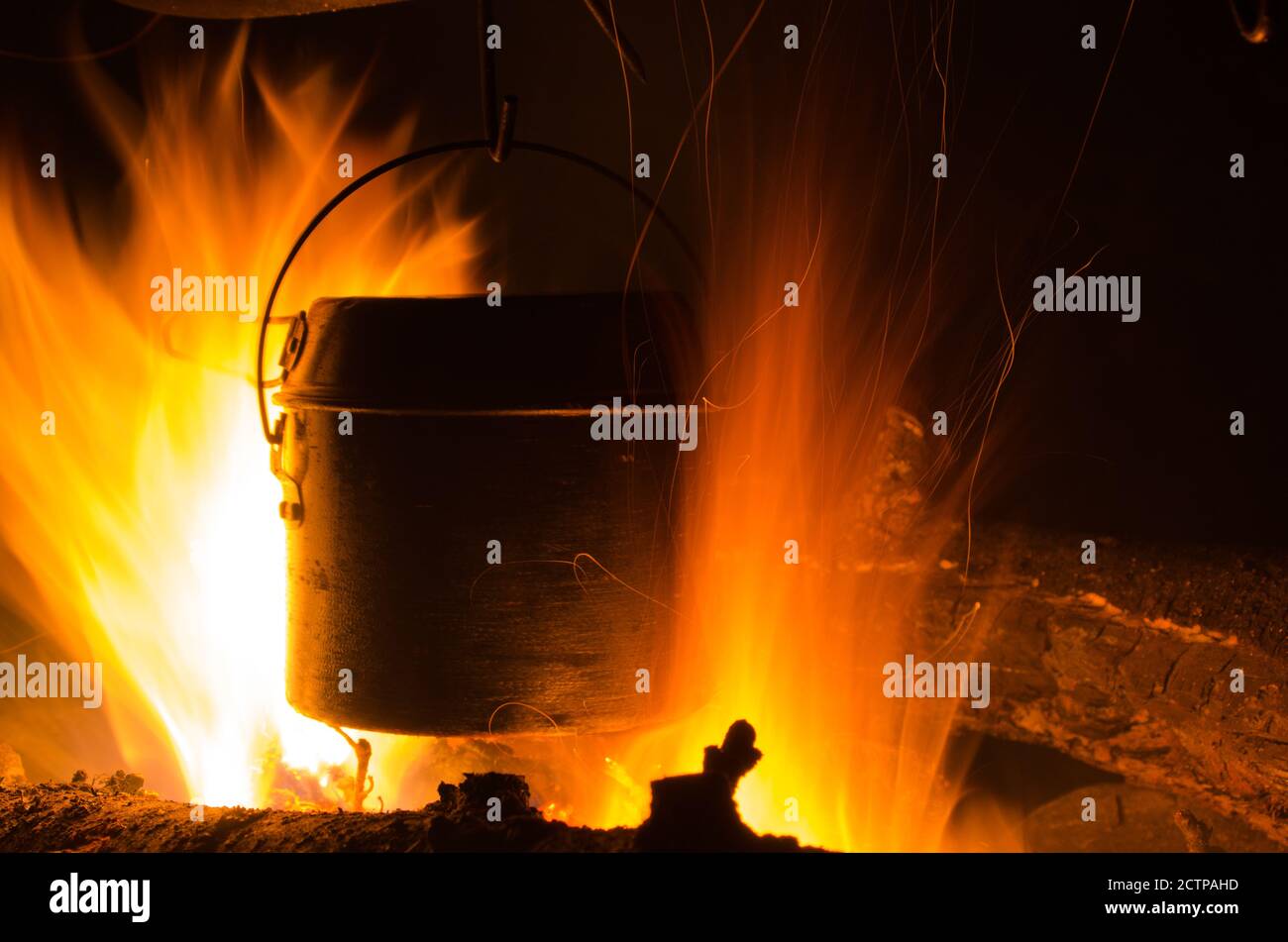 fire burns in the campaign. pot of tea by the fire Stock Photo - Alamy