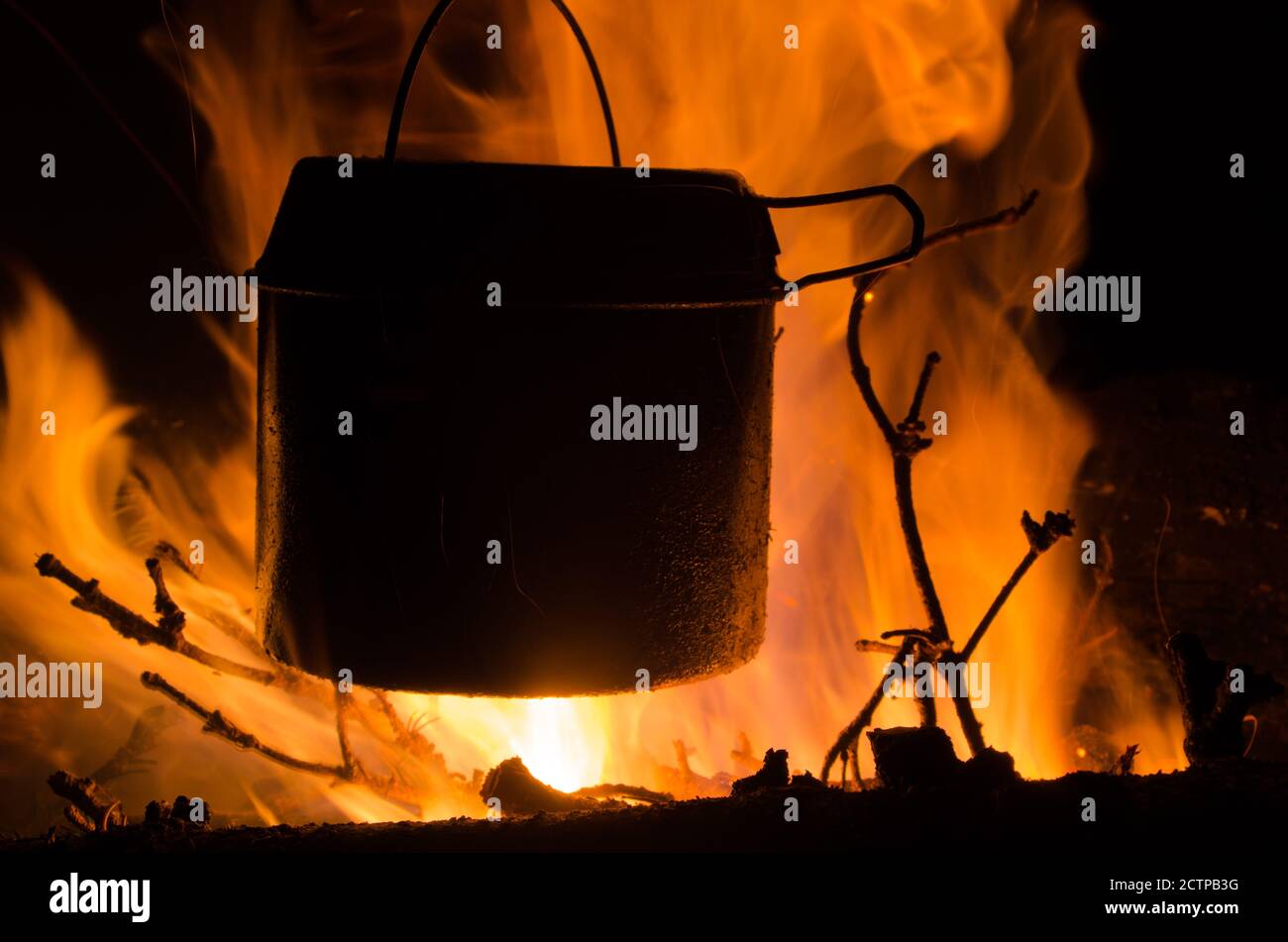 fire burns in the campaign. pot of tea by the fire Stock Photo - Alamy