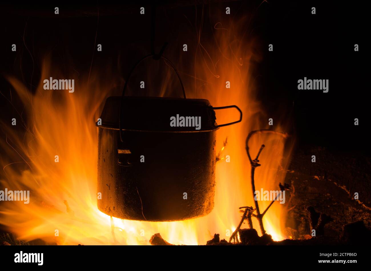 fire burns in the campaign. pot of tea by the fire Stock Photo - Alamy