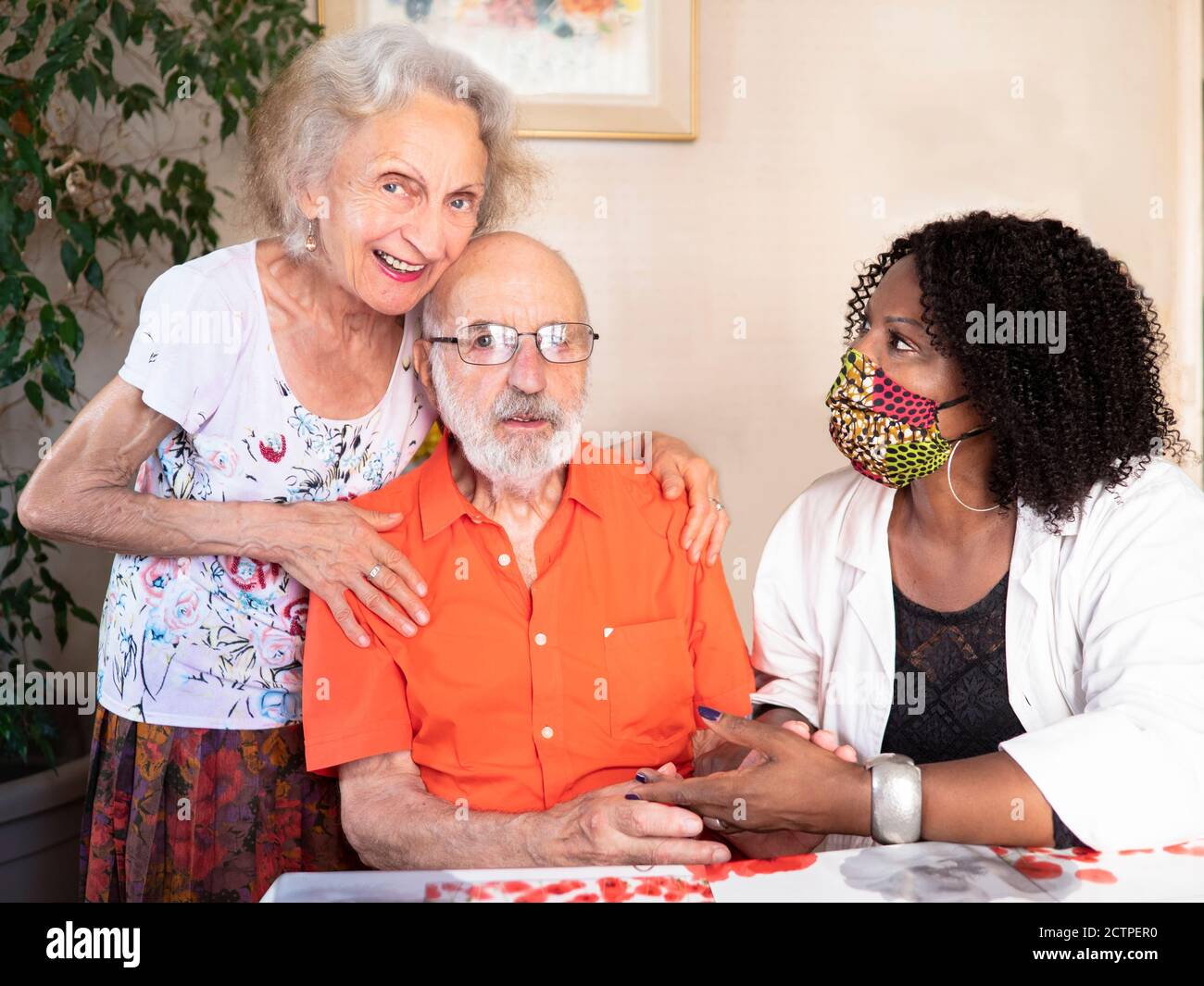 Horizontal portrait of an African American medical assistant helping an ...
