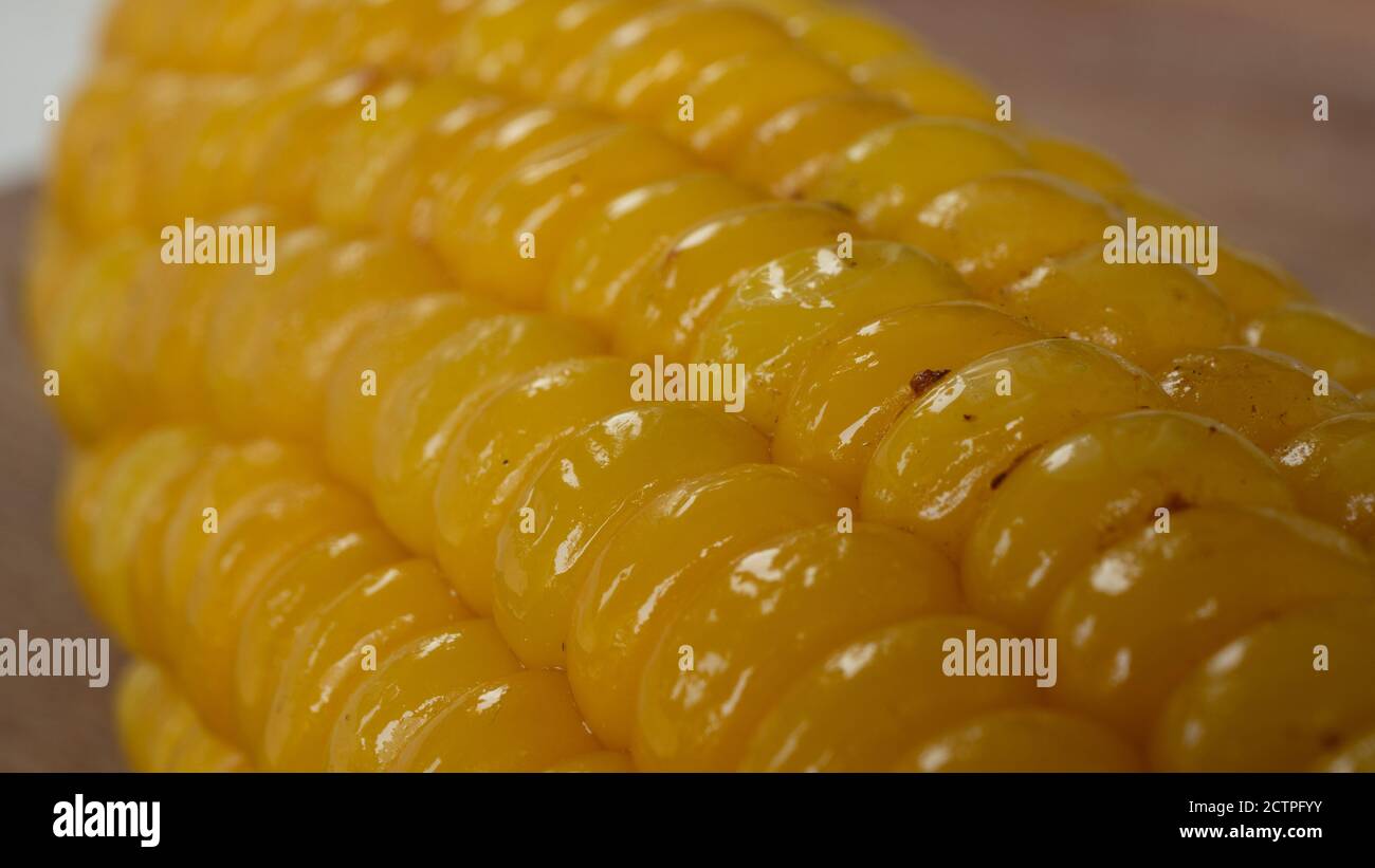 Delicious corn on the cob captured in an extreme close up. The brightly ...