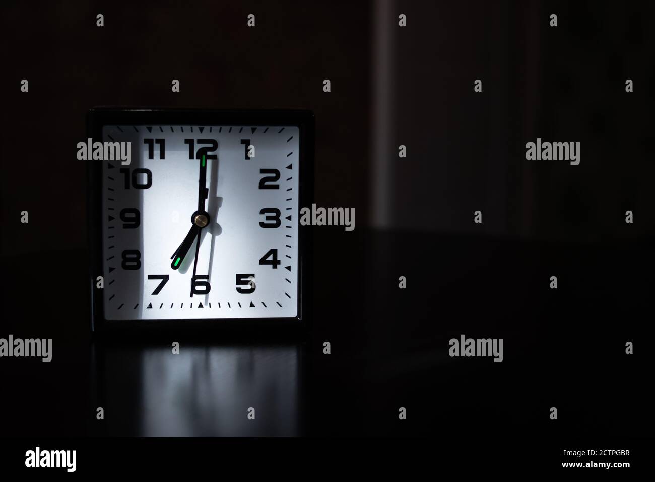 Black clock in morning in shadows closeup Stock Photo - Alamy