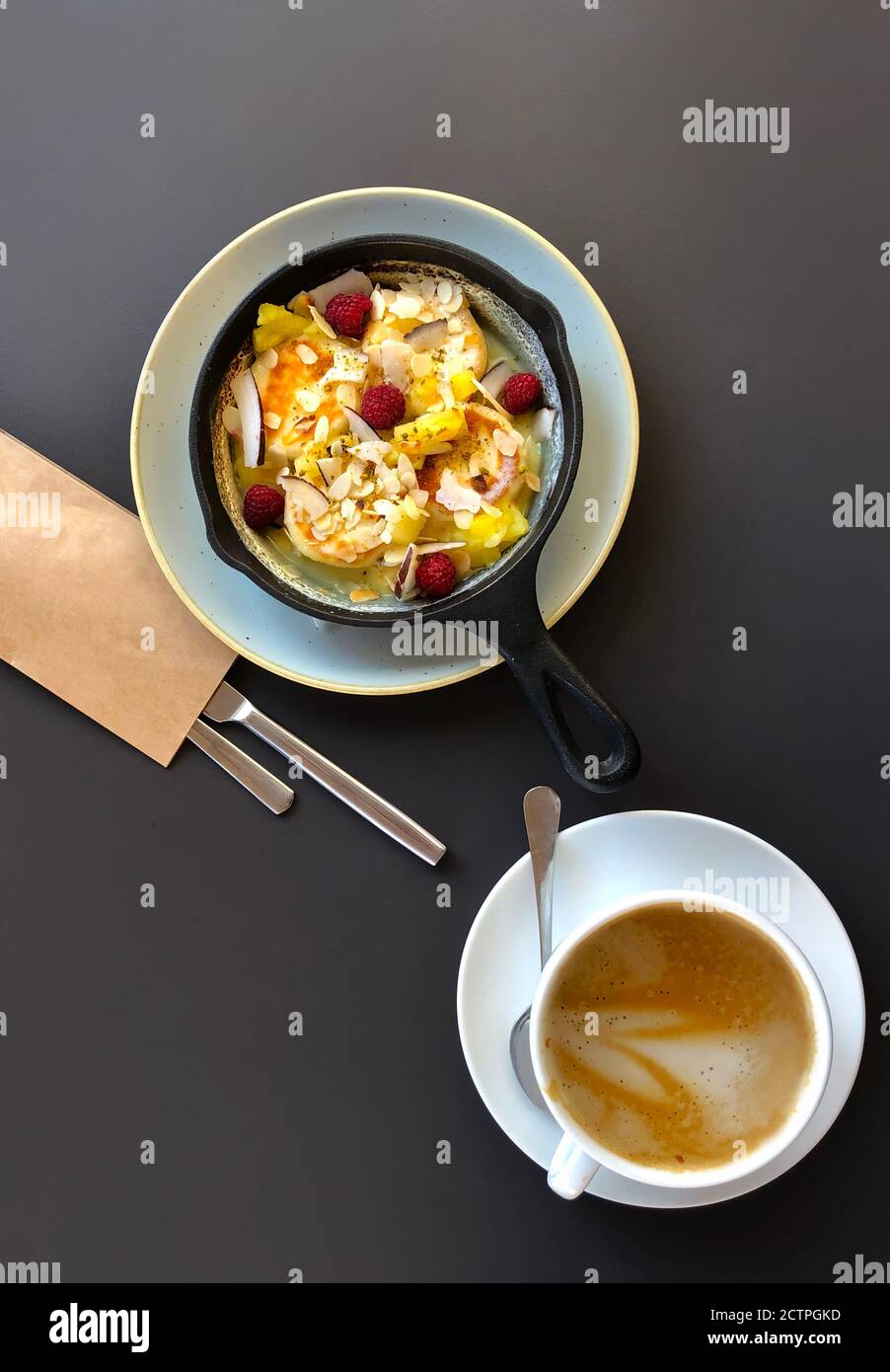 Pan with cheesecake or pancake and berries, cup of coffee on the dark ...