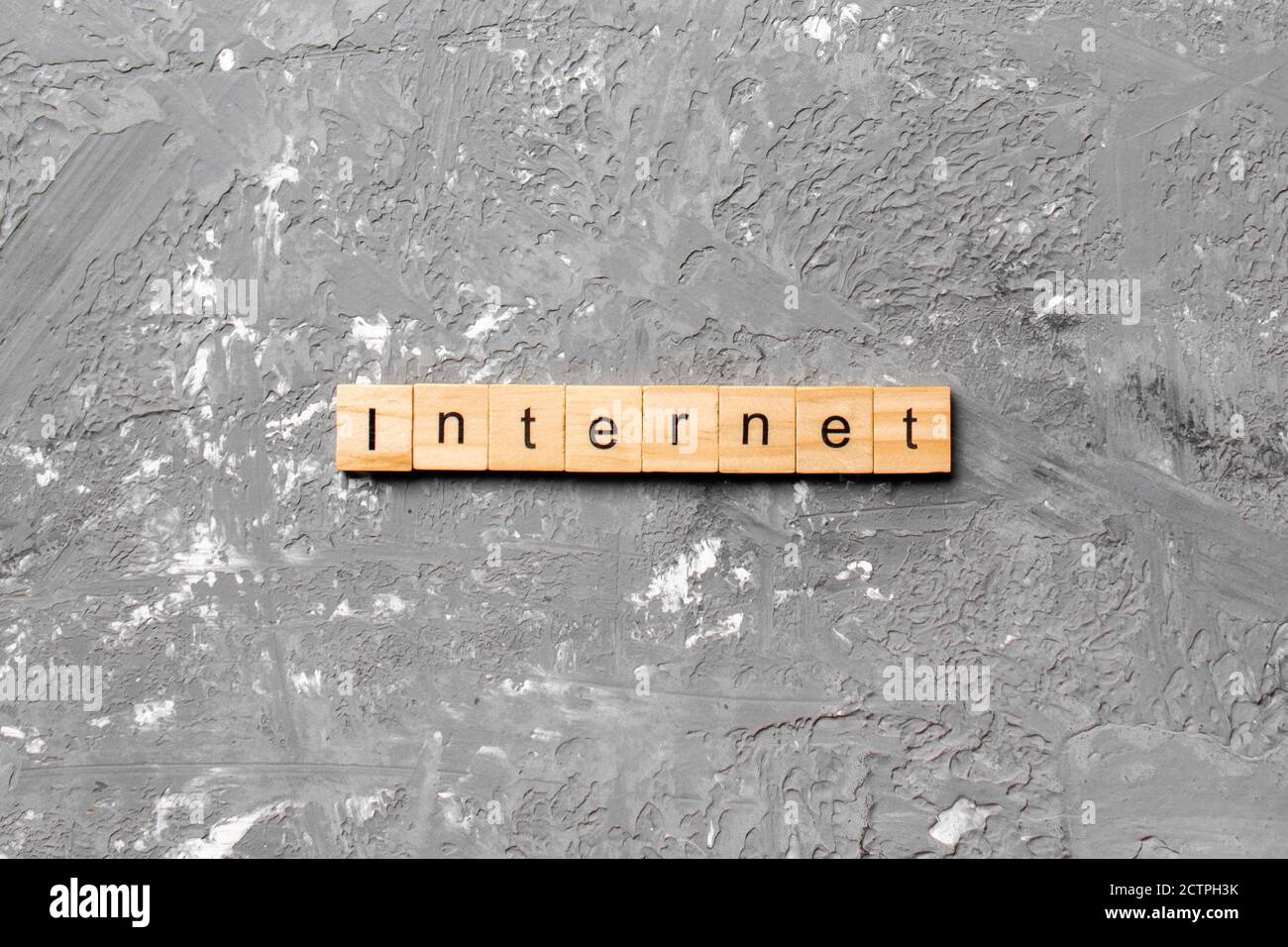 INTERNET word written on wood block. INTERNET text on cement table for ...