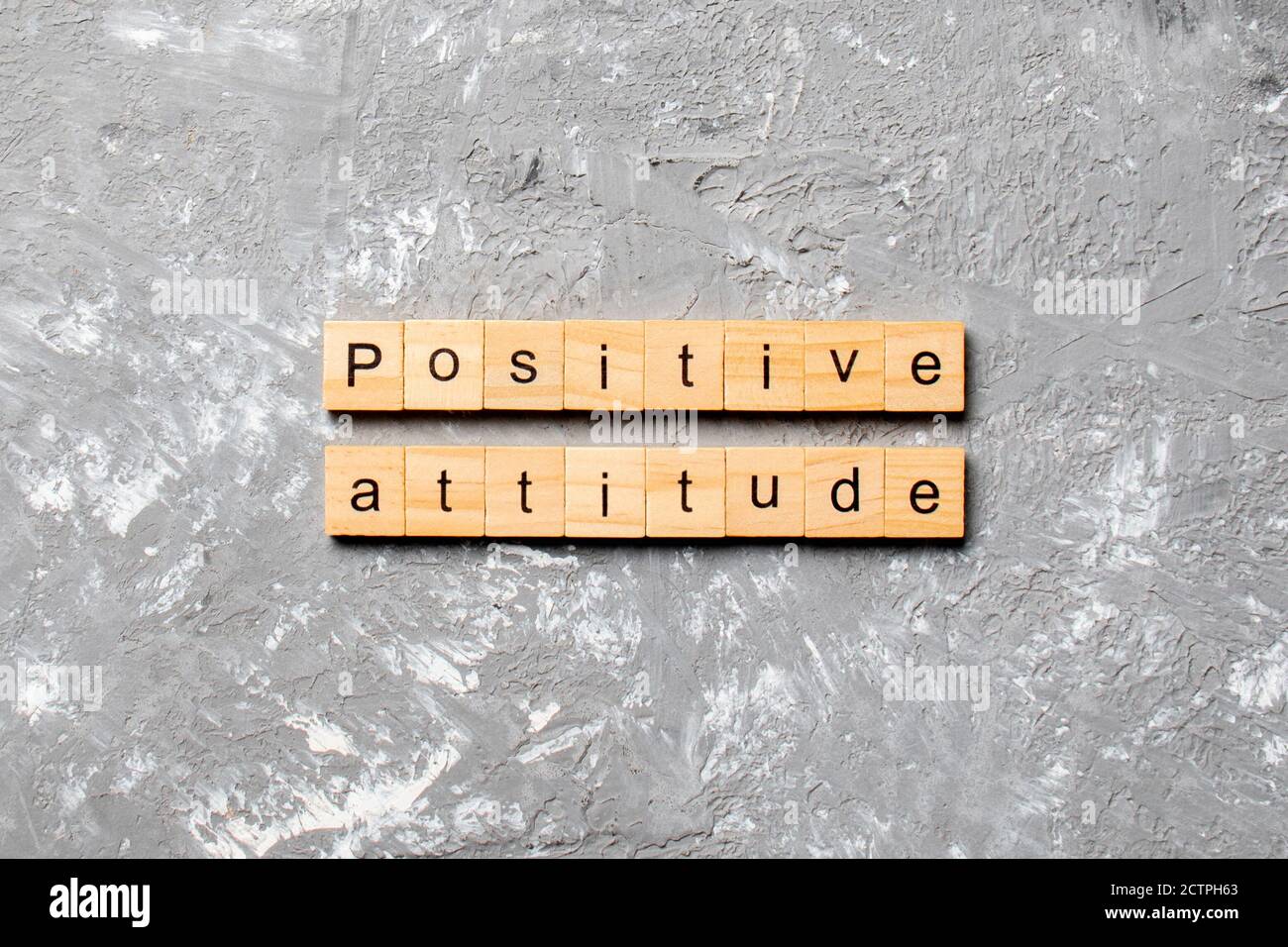 Positive Attitude word written on wood block. Positive Attitude text on ...