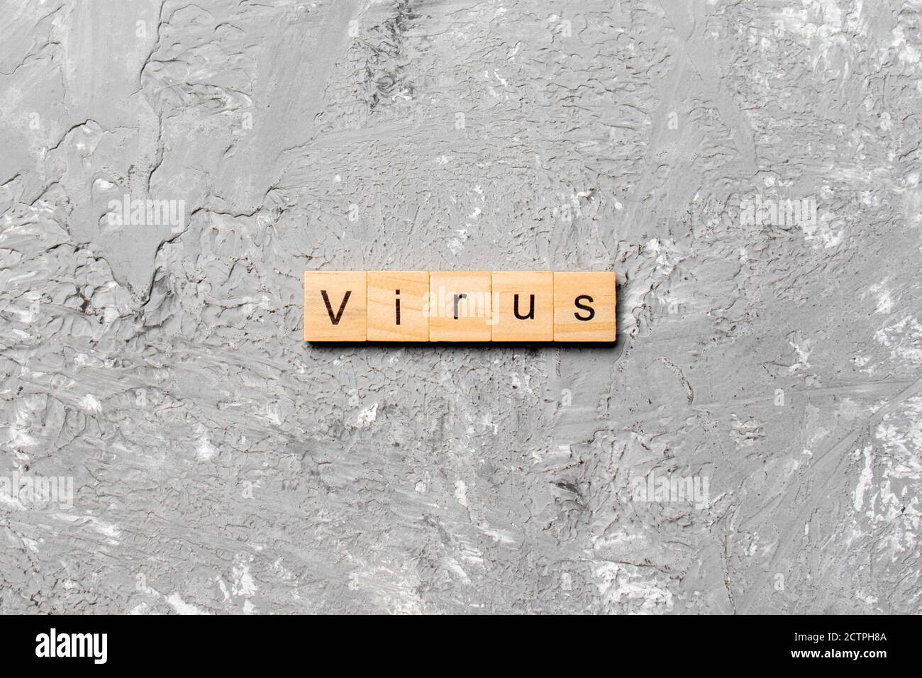 virus word written on wood block. virus text on cement table for your ...
