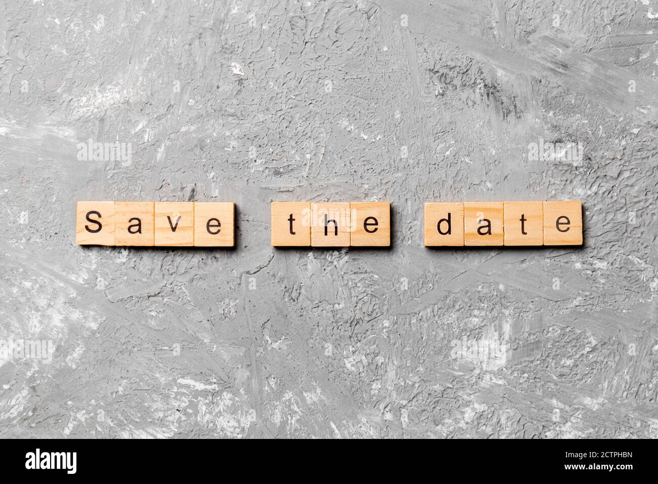 Save the Date word written on wood block. Save the Date text on table ...