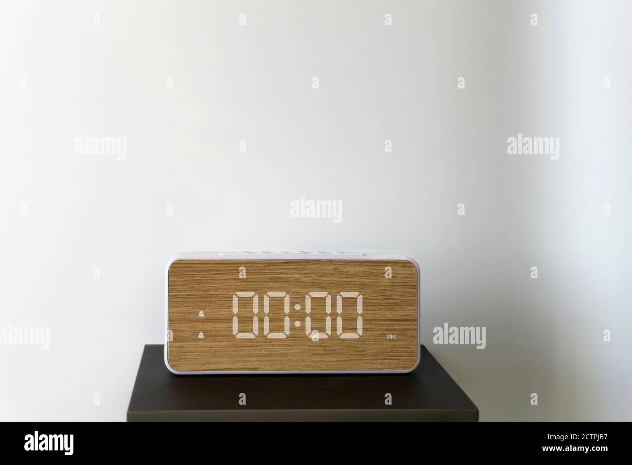 Studio shot of a modern rectangular wooden alarm clock with default ...
