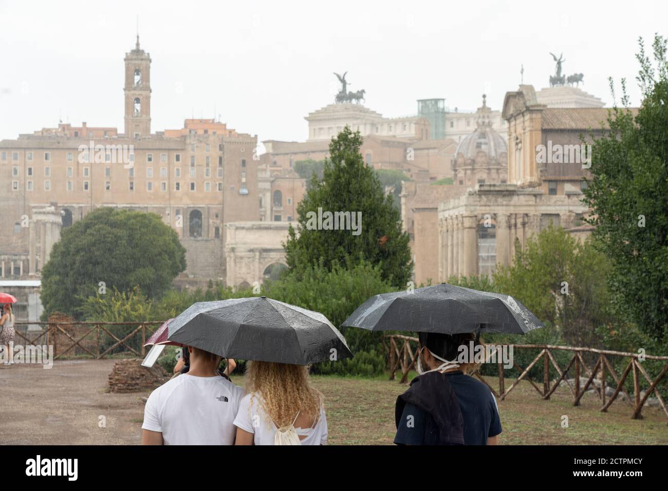 Rome, Italy. 24th September, 2020. Italy Weather: Tourists shelter from ...