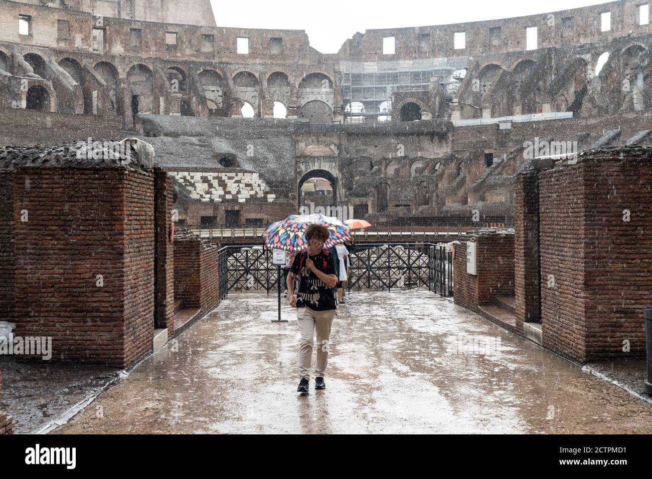 Rome, Italy. 24th September, 2020. Italy Weather: A woman shelters from ...