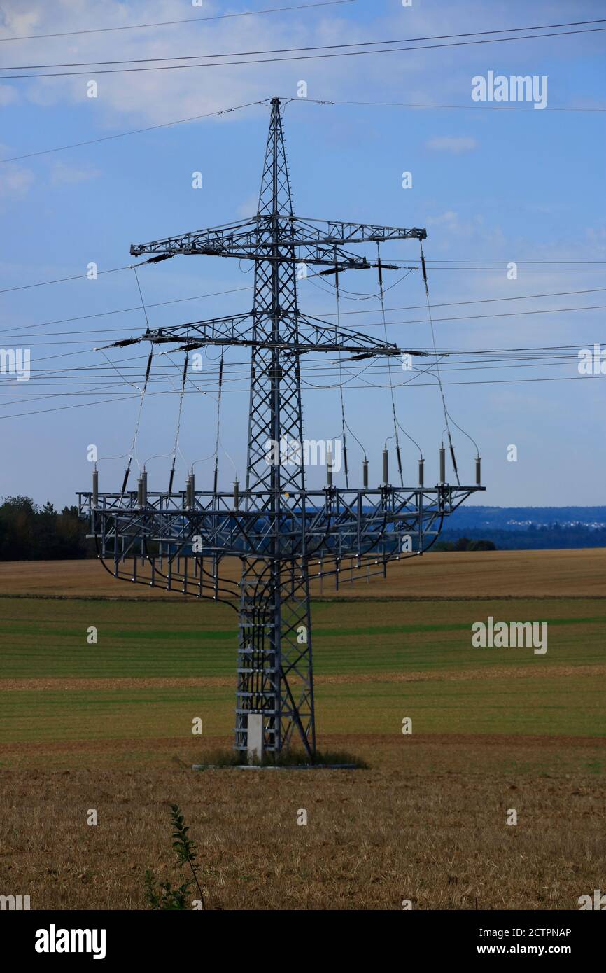 Power pole and power cable in front of a blue sky Stock Photo - Alamy