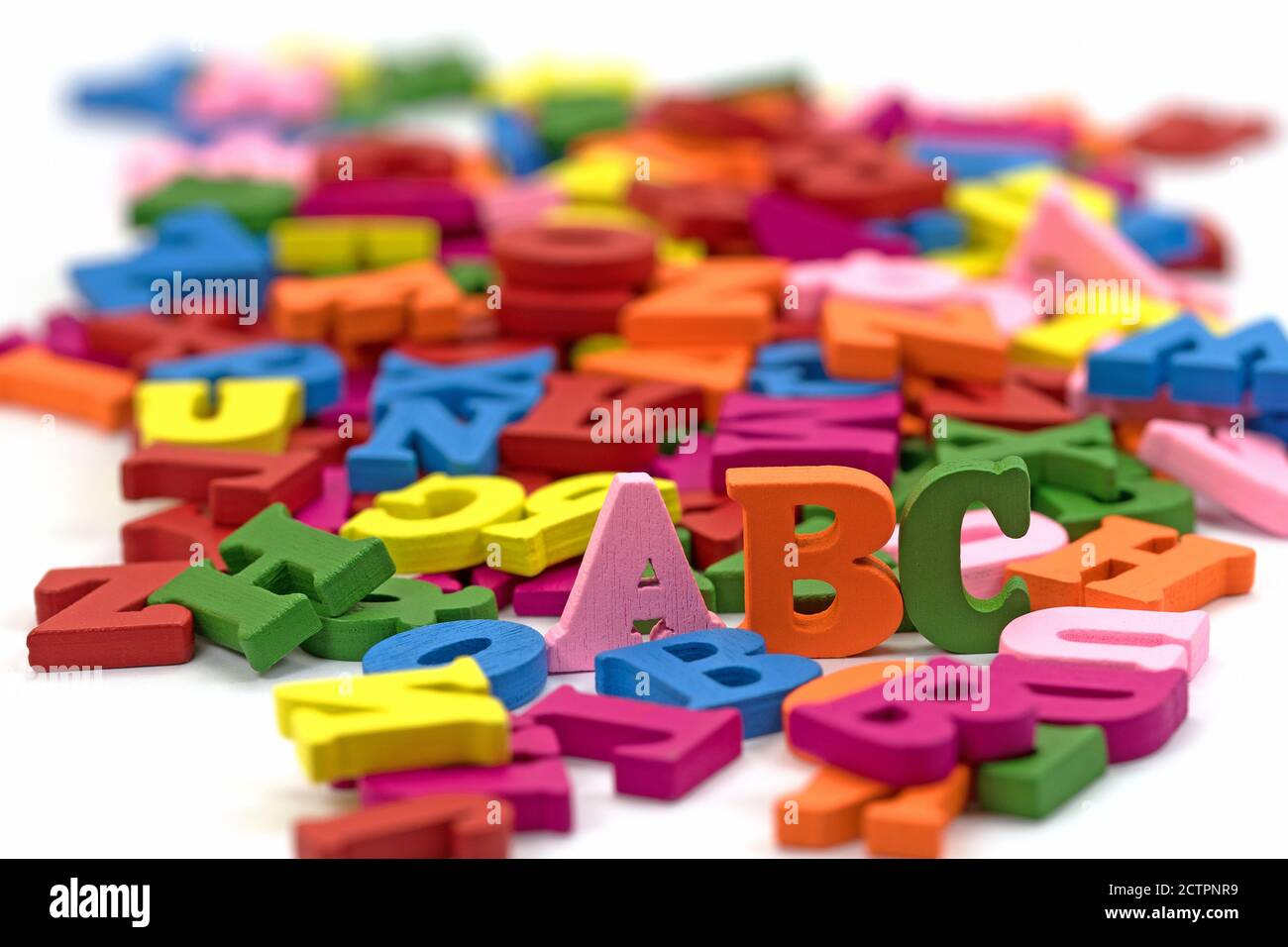 Colorful wooden letters against white background Stock Photo - Alamy