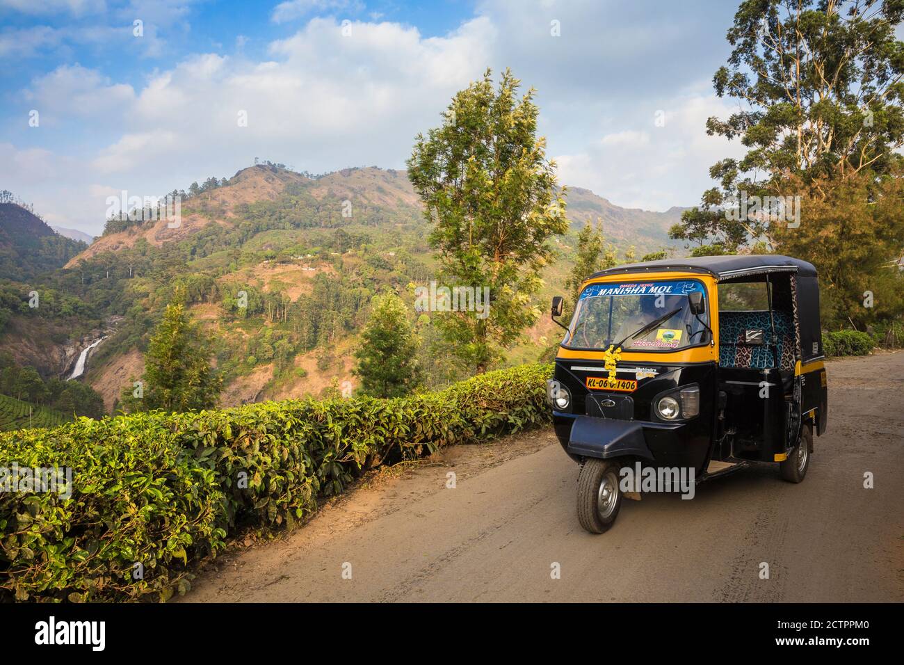 India, Kerala, Munnar, Auto rickshaw on road near Attukad Waterfalls ...