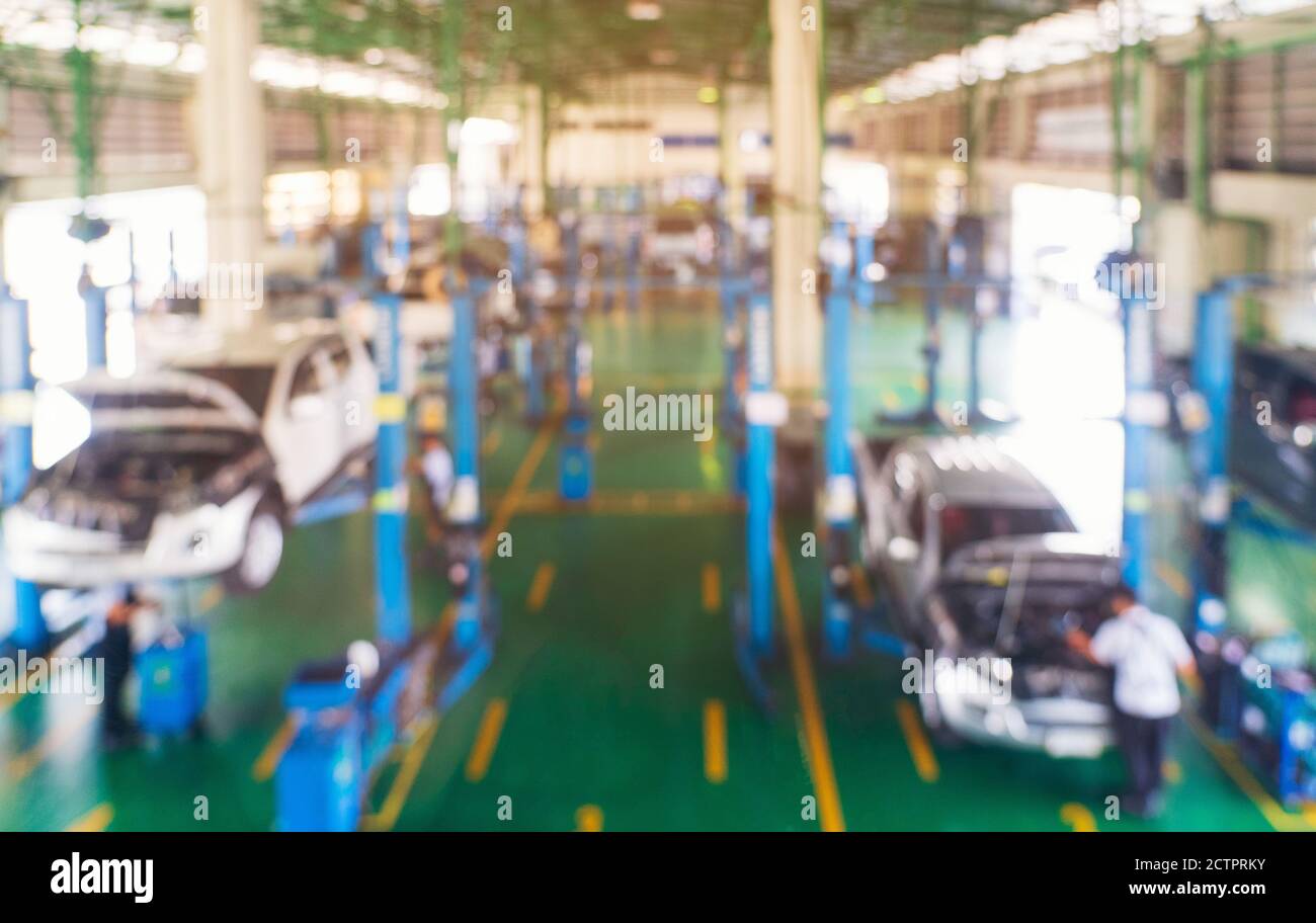 Blurred background of technician repairing the car in garage,mechanics ...