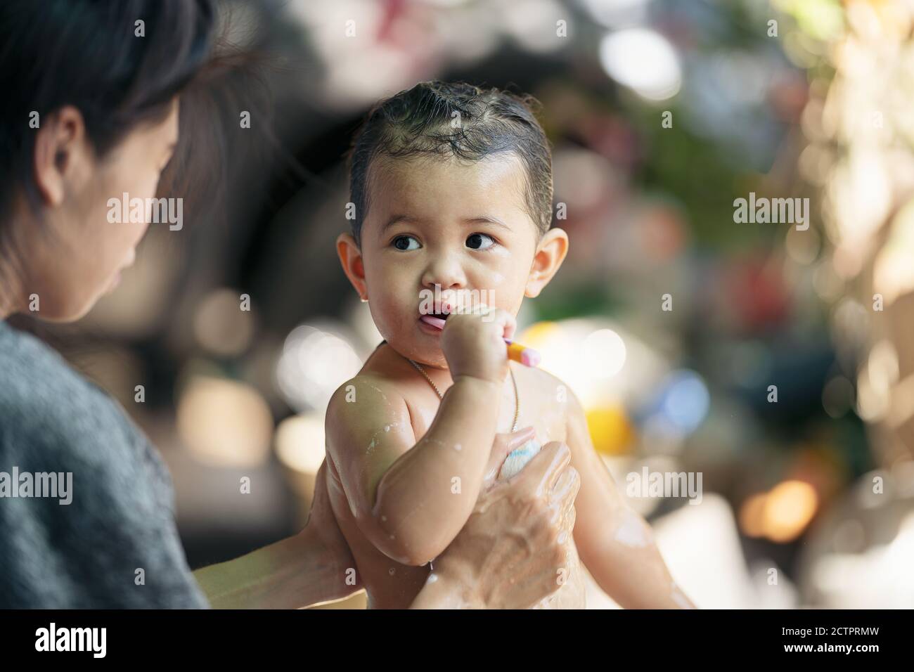 Dental hygiene. Asian mother and cute girl or kid brushing her teeth by ...
