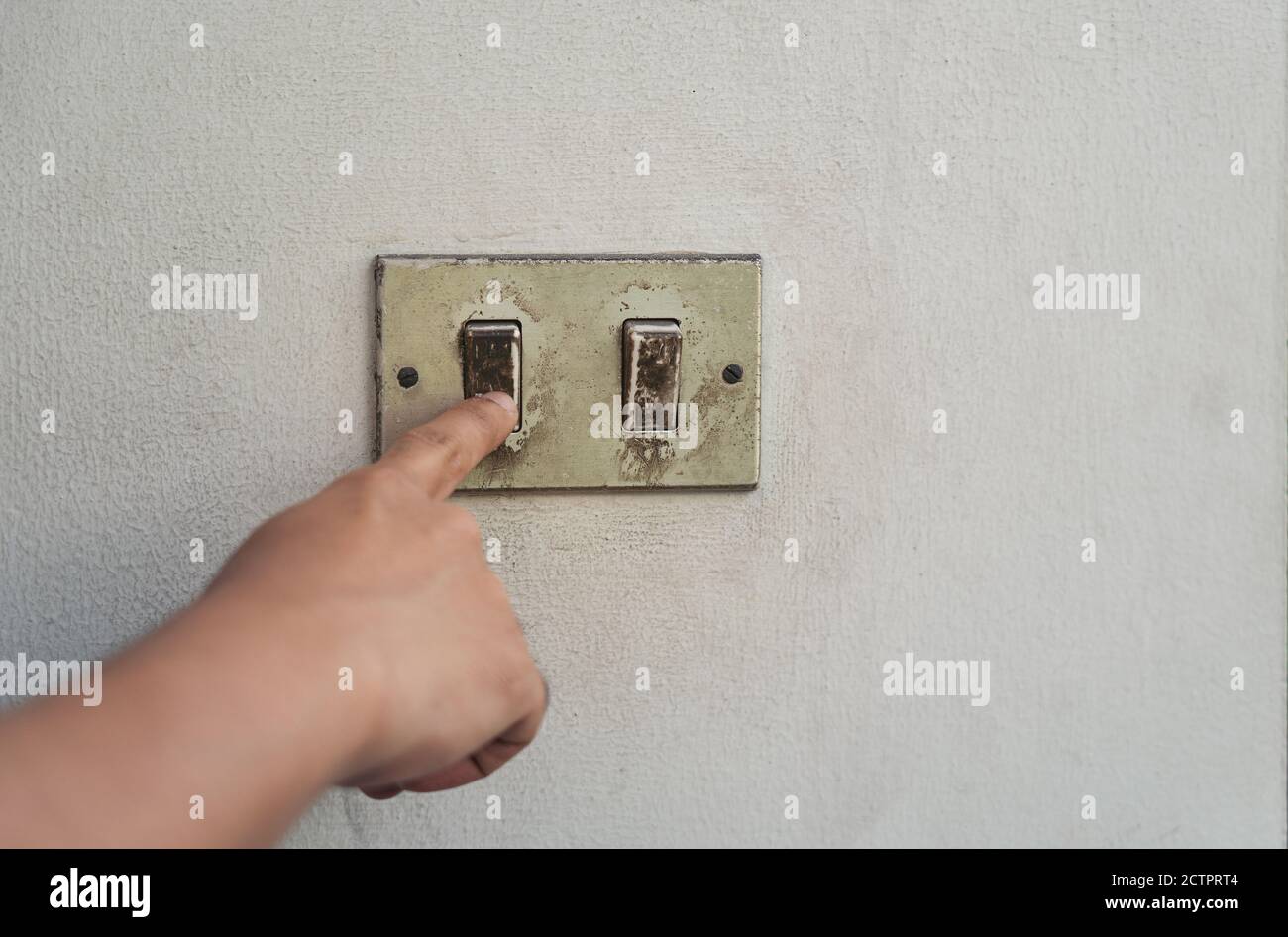 Hand turning the old electrical switches off. Power on/off switches ...
