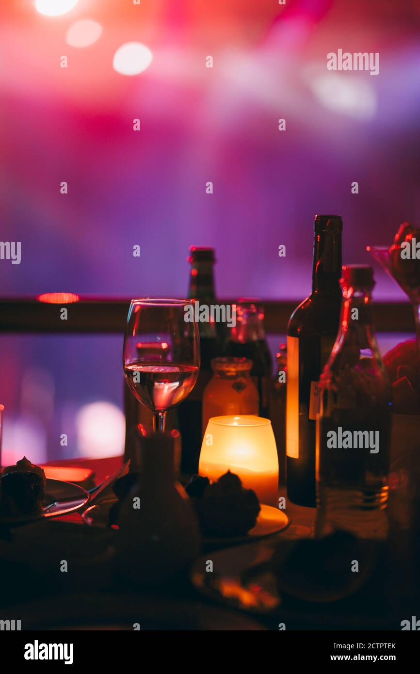 Romantic night in restaurant with wine glass and different types of ...