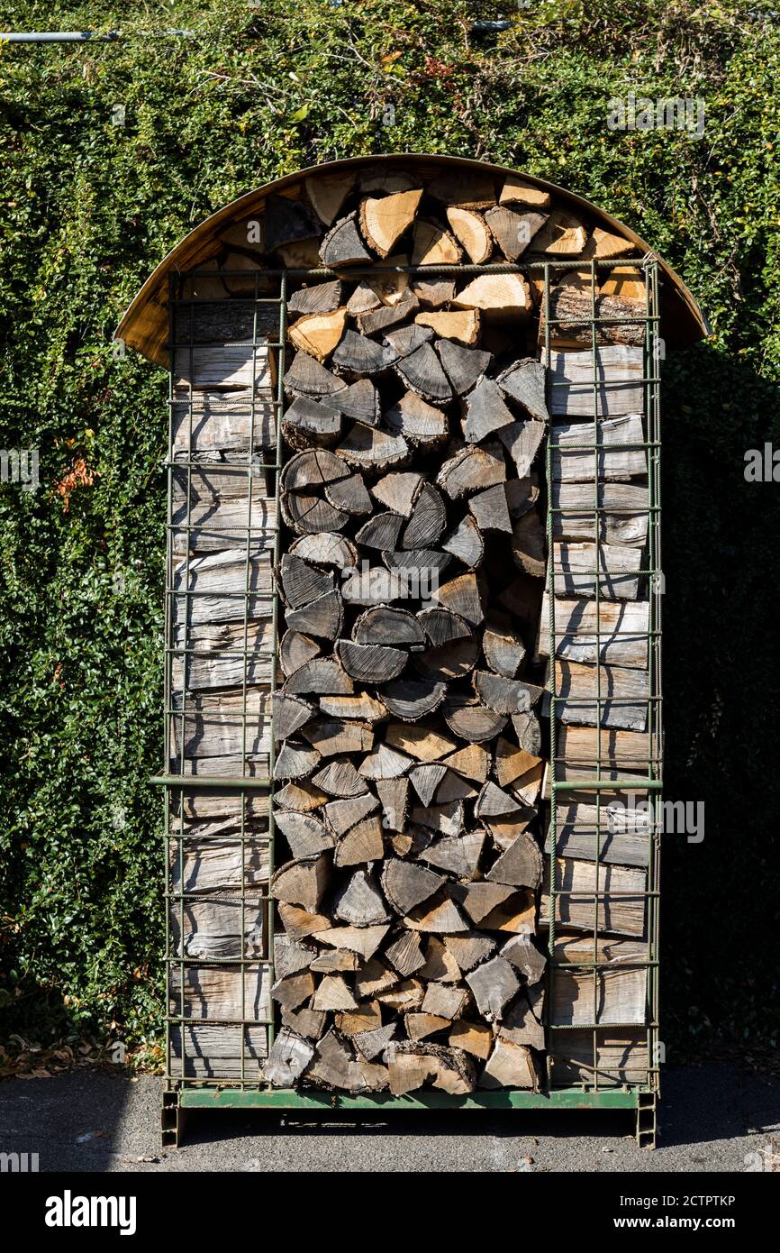 Fun log store with curved roof and packed with cut logs, Germany Stock ...