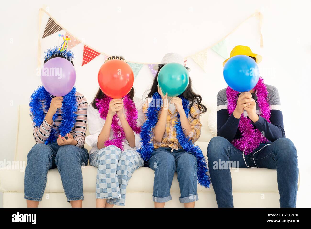 Group of children play with air balloons, confetti in light room on ...