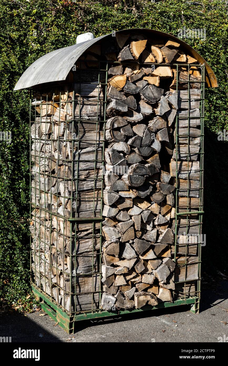 Fun log store with curved roof and packed with cut logs, Germany Stock ...
