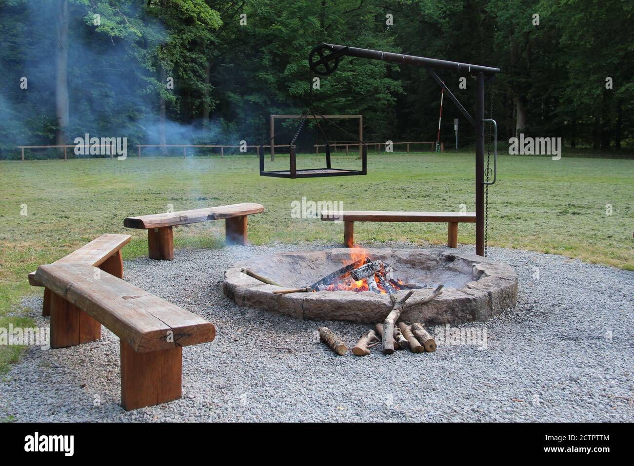 Camping place for a bonfire with burning wood logs and bunches Stock ...