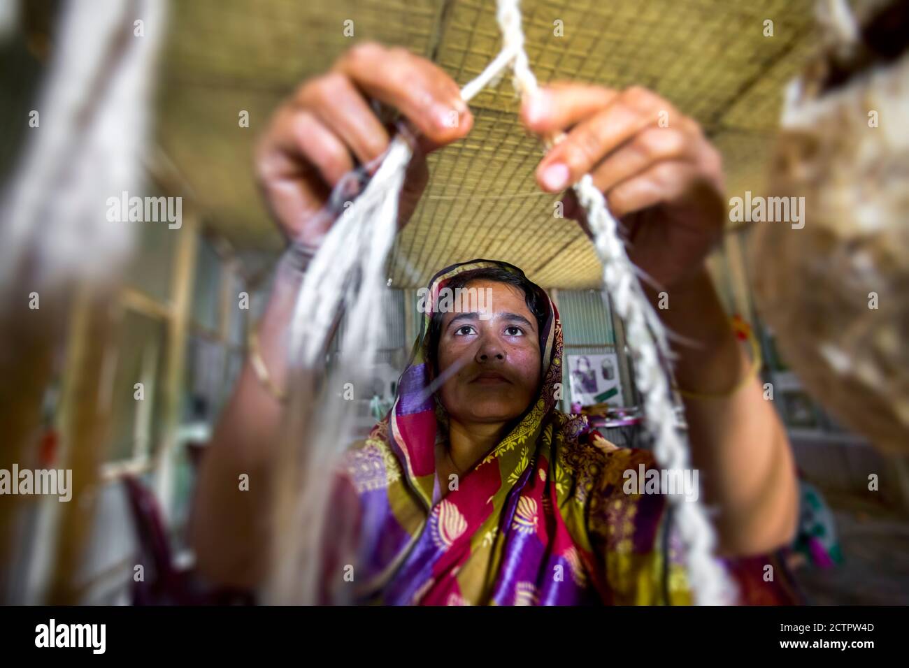 Bangladesh – May 13, 2018: Handicraft maker women is making a rope from ...