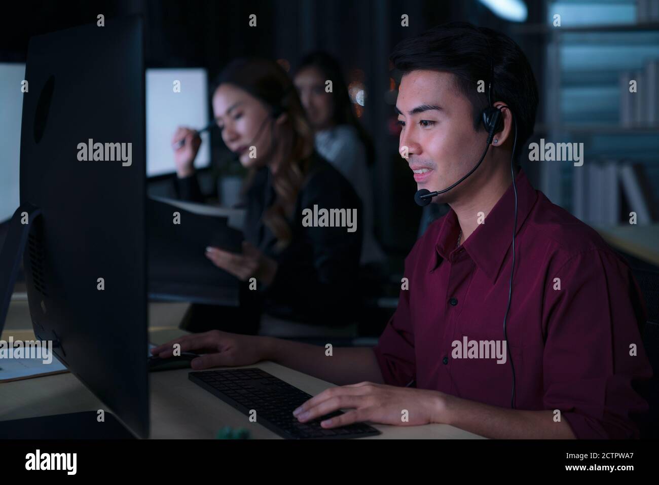 Thai Asian man customer services care operators working night shift in ...