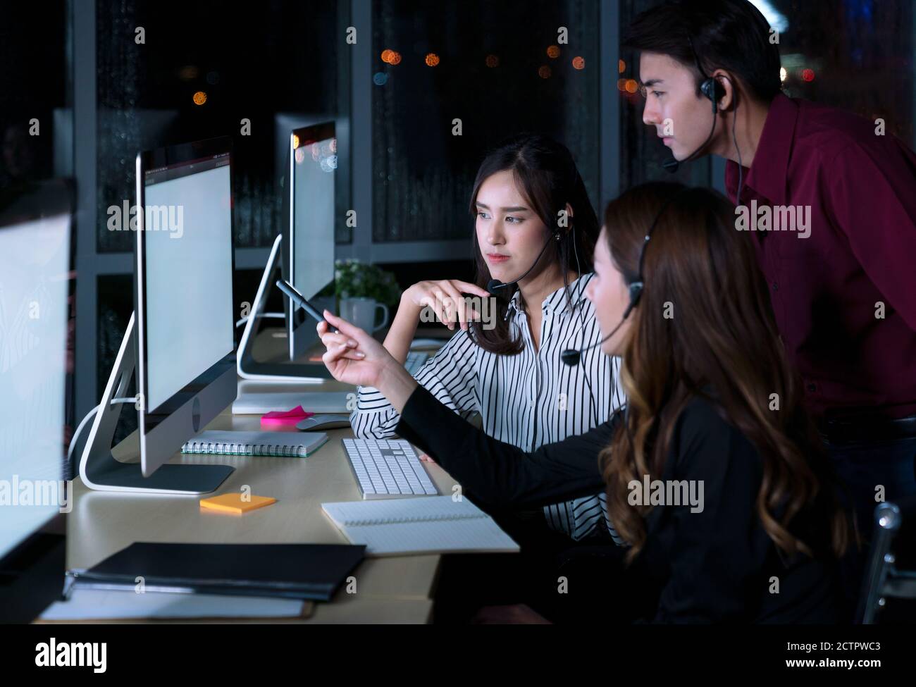 Young Thai Asian customer services care operators working night shift ...