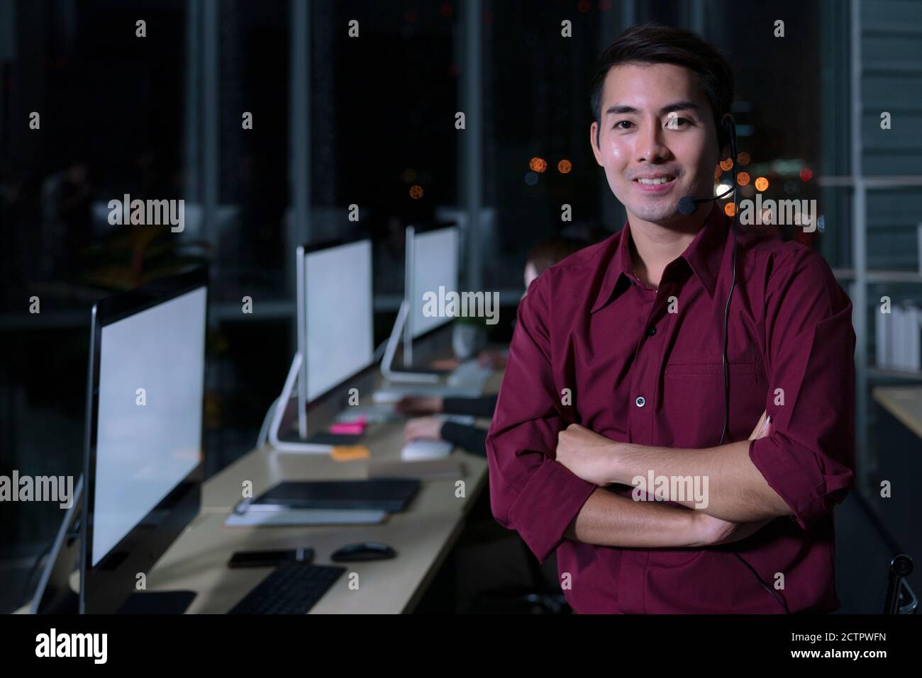 Thai Asian man customer services care operators working night shift in ...