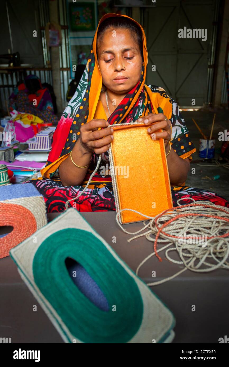 A Handicraft maker woman is making on some colorful tissue boxes using ...