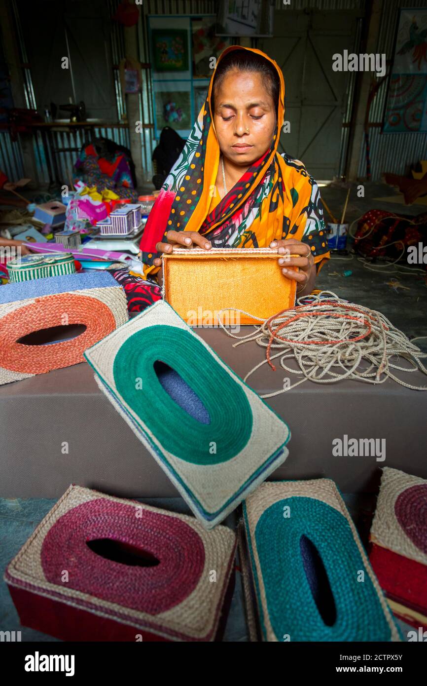 A Handicraft maker woman is making on some colorful tissue boxes using ...