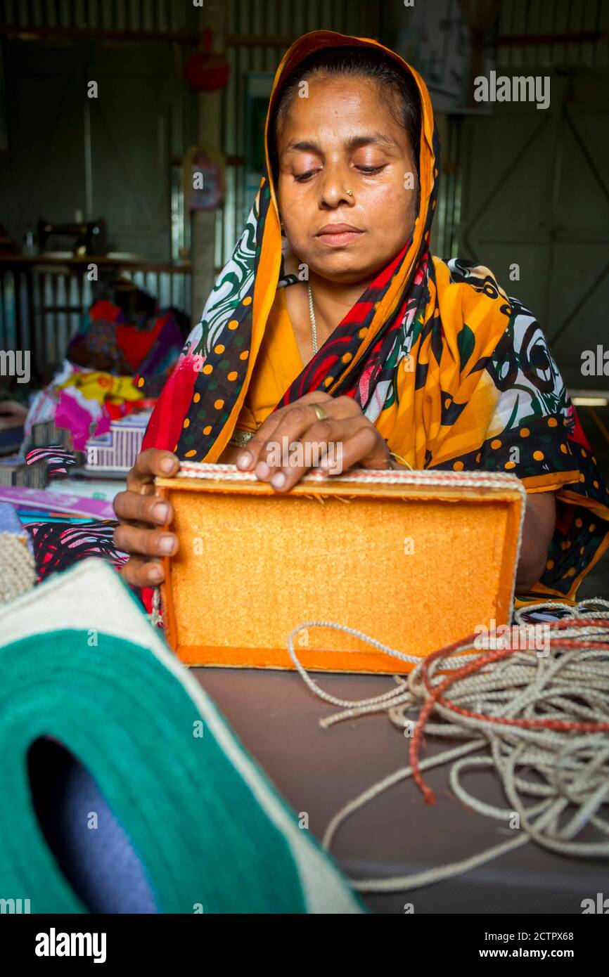 A Handicraft maker woman is making on some colorful tissue boxes using ...