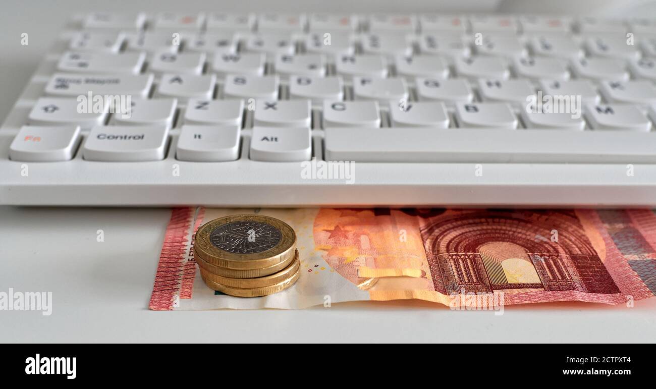 Closeup shot of money and coins on the computer keyboard Stock Photo ...