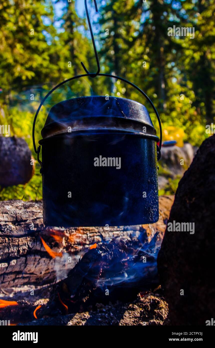 fire burns in the campaign. pot of tea by the fire Stock Photo - Alamy