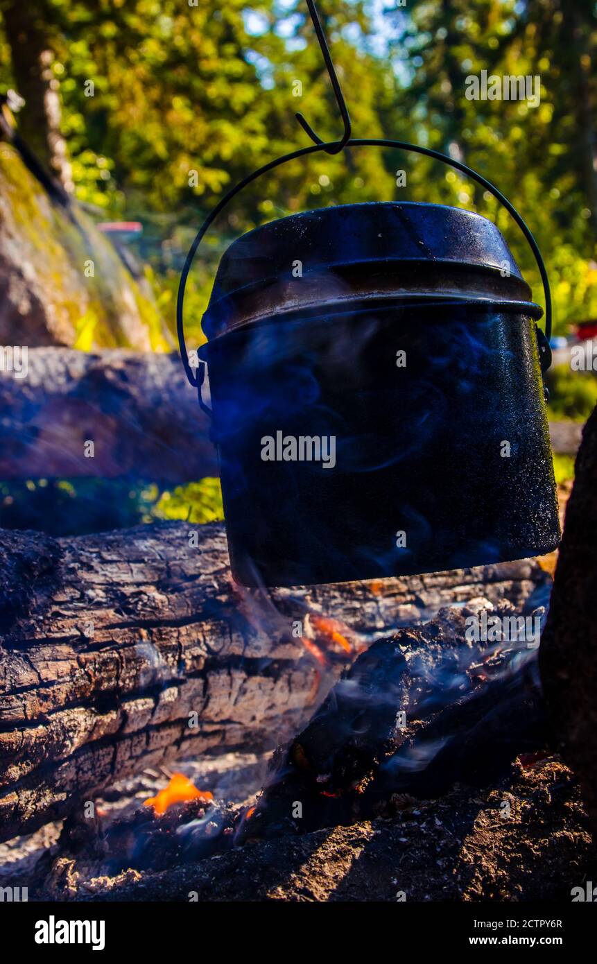 fire burns in the campaign. pot of tea by the fire Stock Photo - Alamy