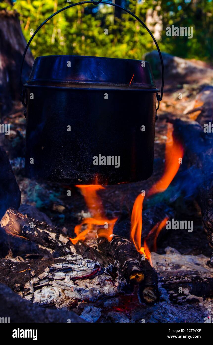 fire burns in the campaign. pot of tea by the fire Stock Photo - Alamy