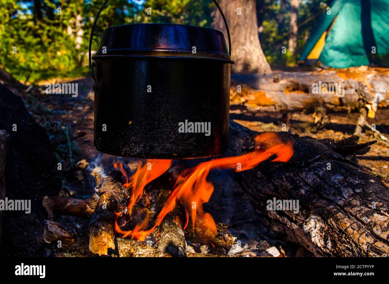 fire burns in the campaign. pot of tea by the fire Stock Photo - Alamy