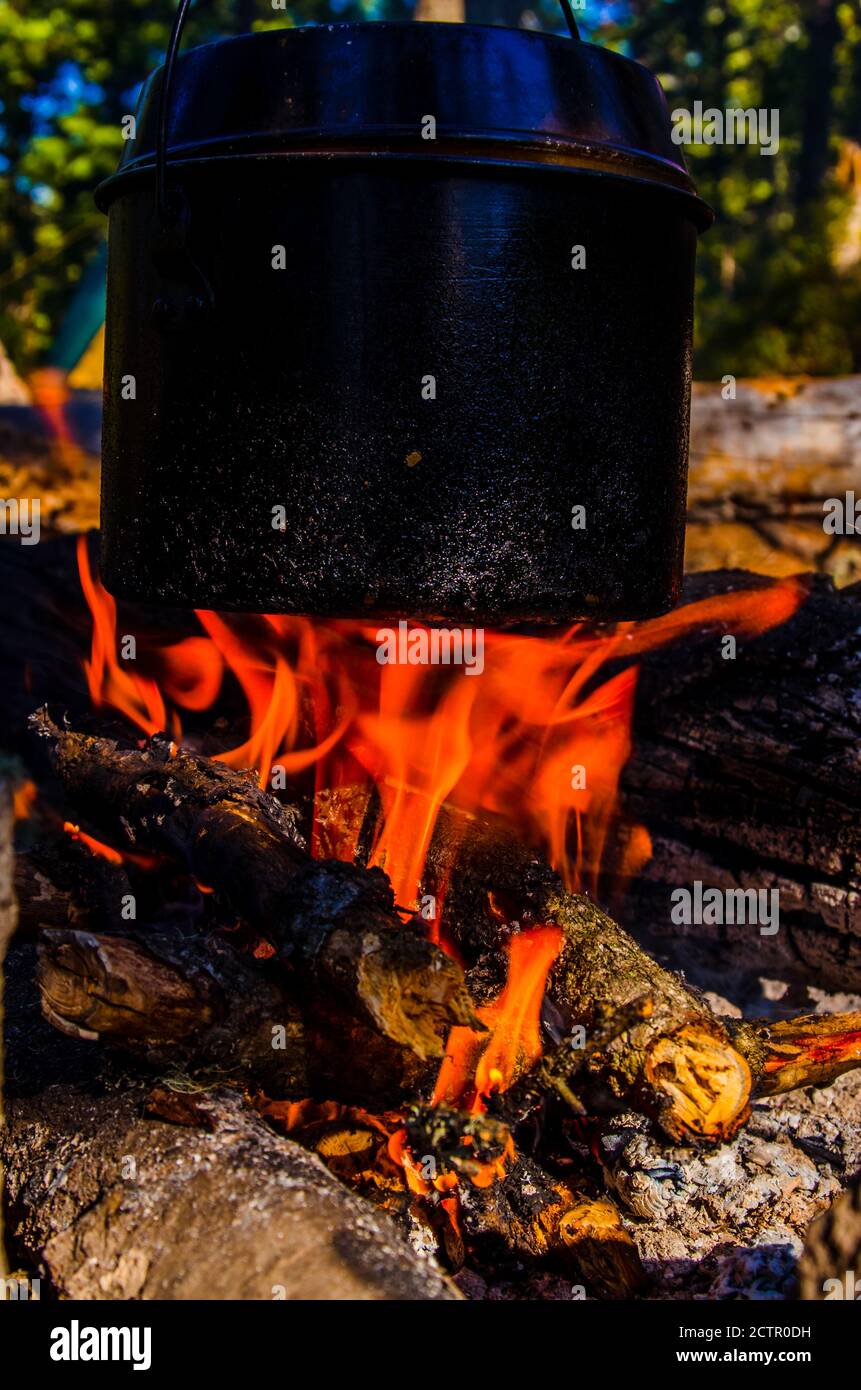 fire burns in the campaign. pot of tea by the fire Stock Photo - Alamy