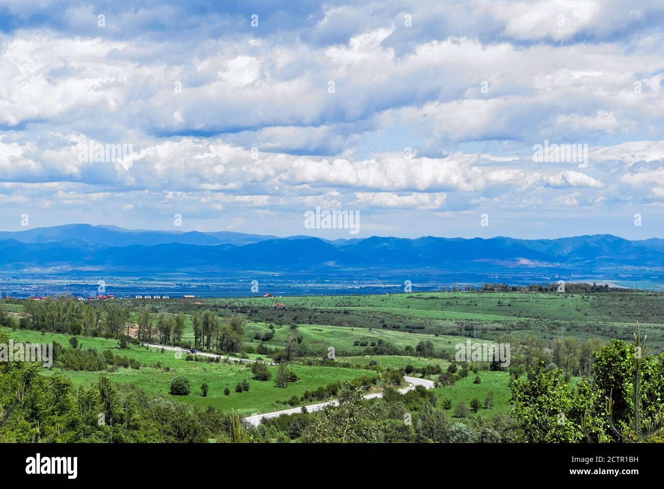 Landscape with green fields and mountains Stock Photo - Alamy