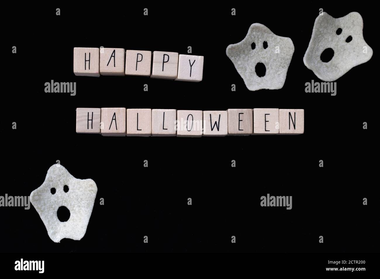 Words Happy Halloween with various ghost on black background top view ...
