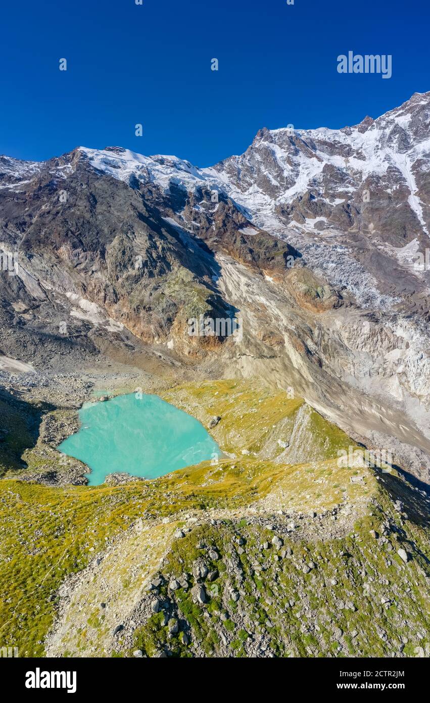 Aerial view of the Locce lake and the Mount Rosa massif. Alpe Pedriola ...